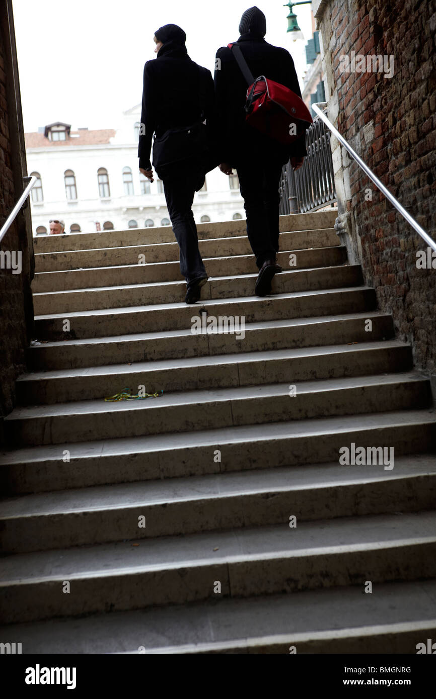 Silhouetted couple walking up steps in Venice, Italy Stock Photo - Alamy