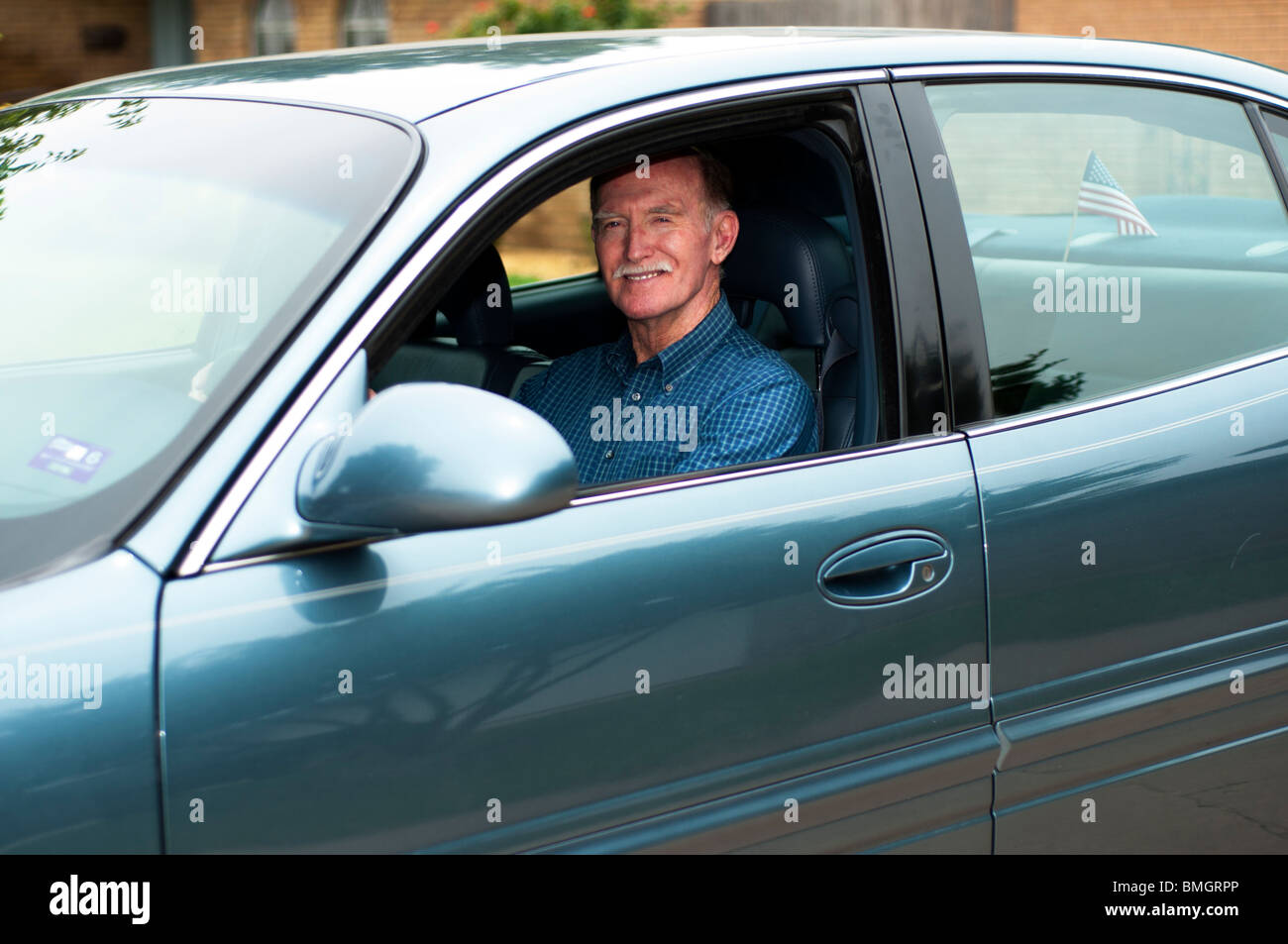 A old man sits in his car in his driveway and smiles. USA Stock Photo ...
