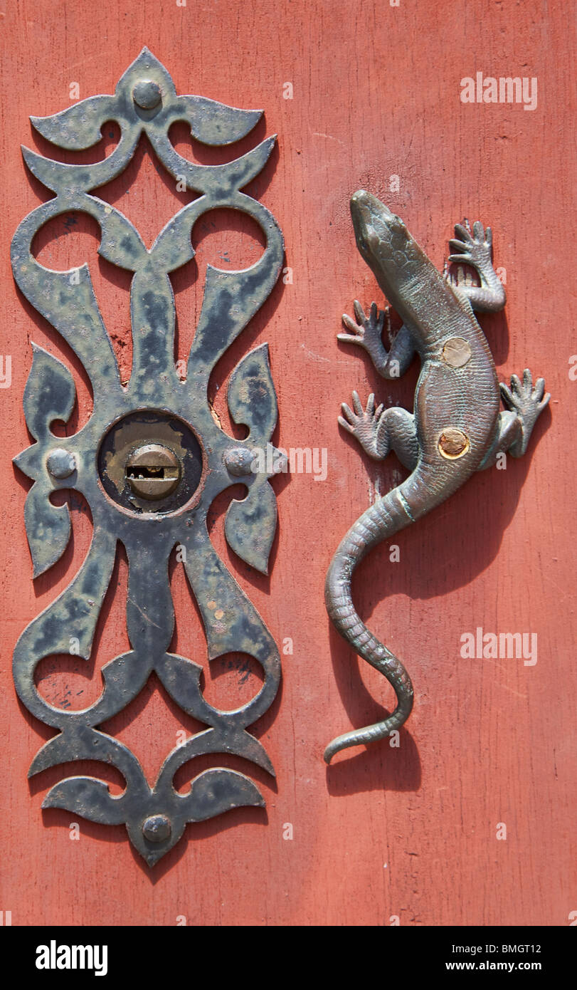 Rustic Door Lock with a Lizard on a Faded Red Door Stock Photo - Alamy