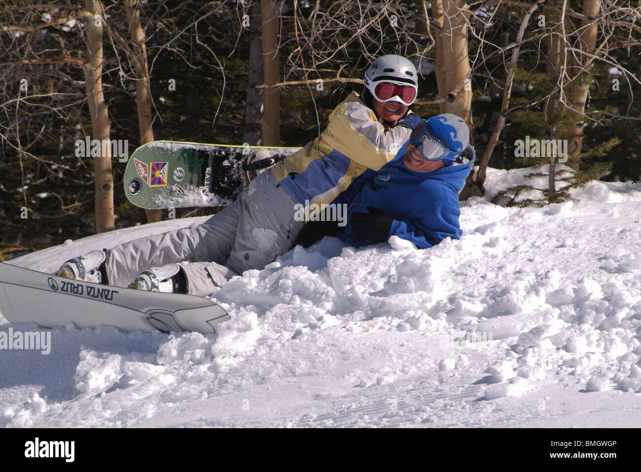 Snowboarders laying in snow Stock Photo - Alamy