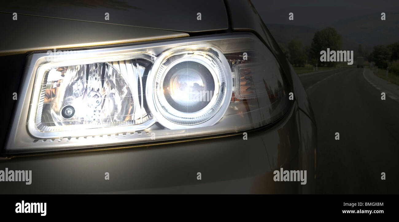 Car on the road. Close-up of the headlight Stock Photo - Alamy