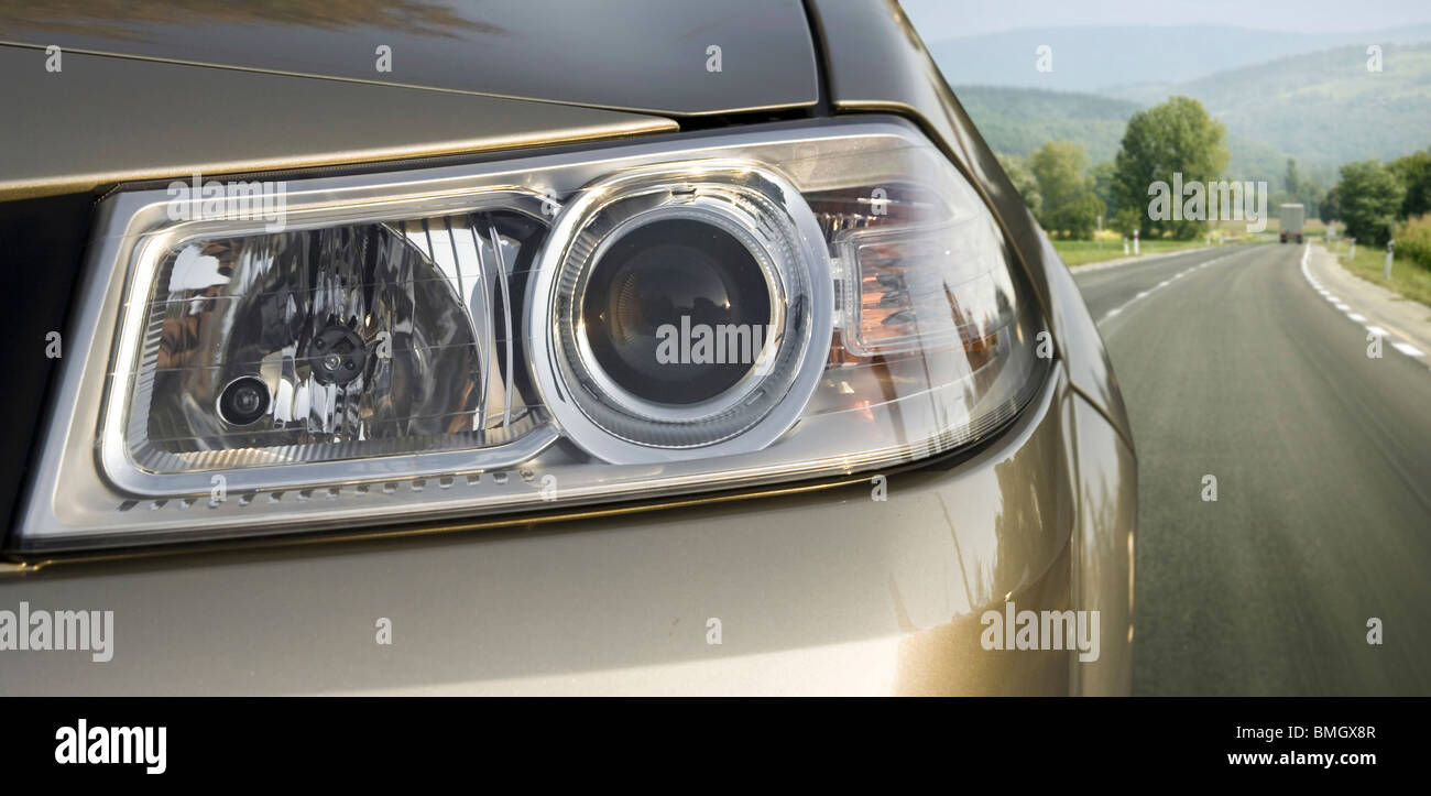 Car on the road. Close-up of the headlight Stock Photo - Alamy