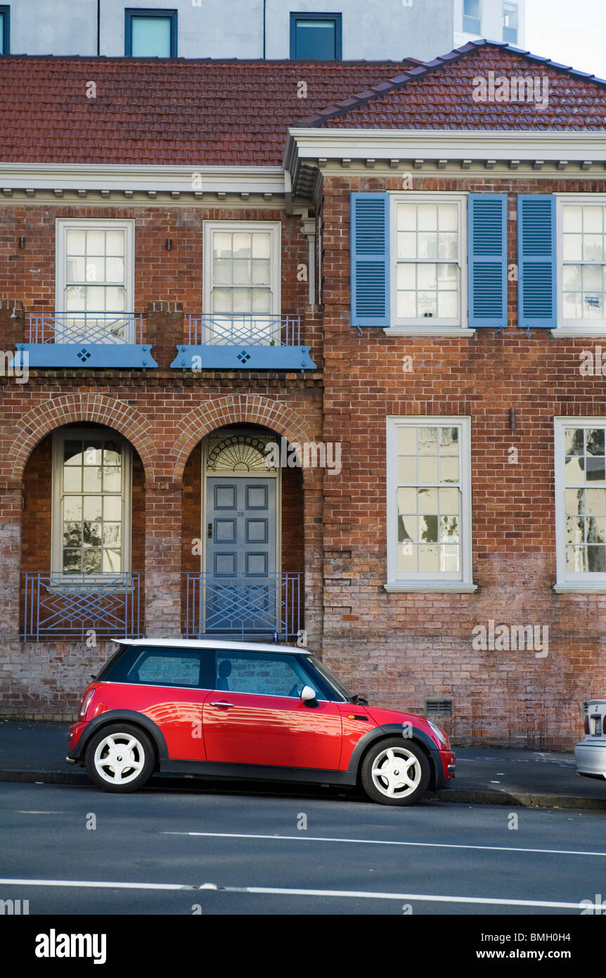 A red Mini Cooper in front a vintage brick house, Auckland, New Zealand ...