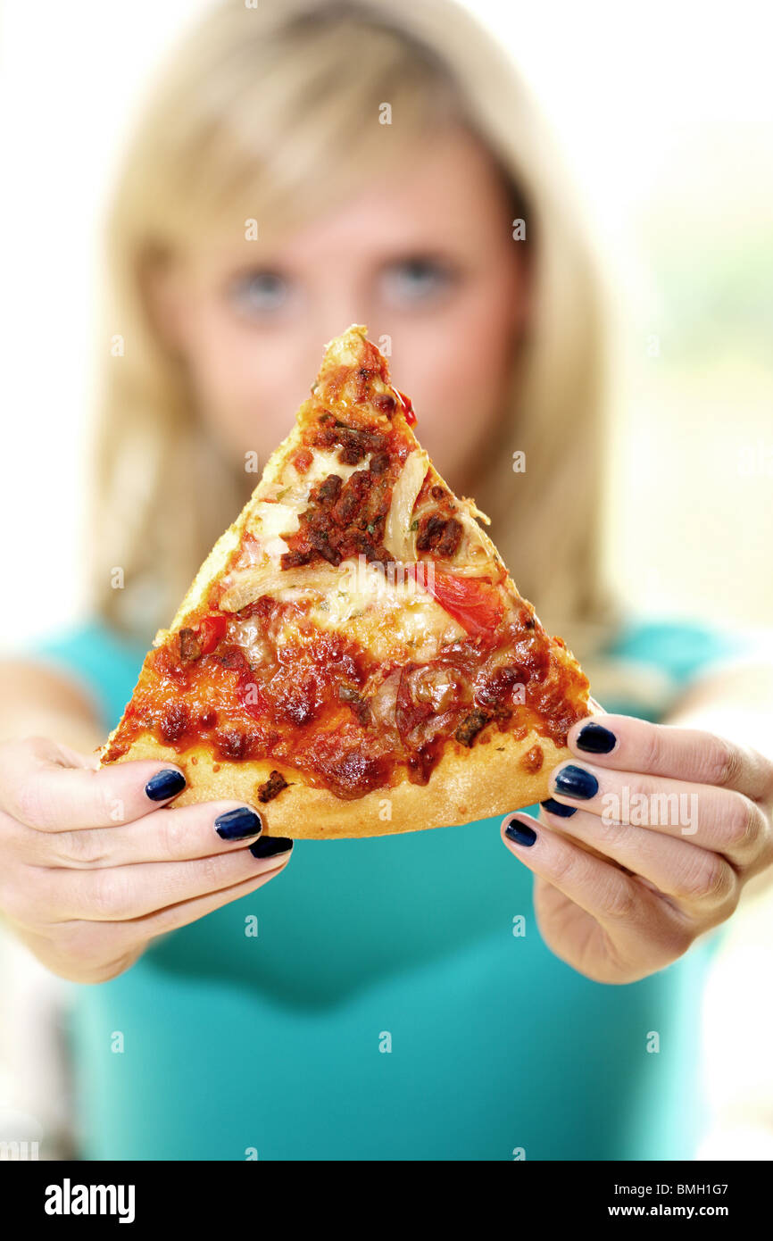 Teenage Girl Eating Pizza Slice. Model Released Stock Photo - Alamy