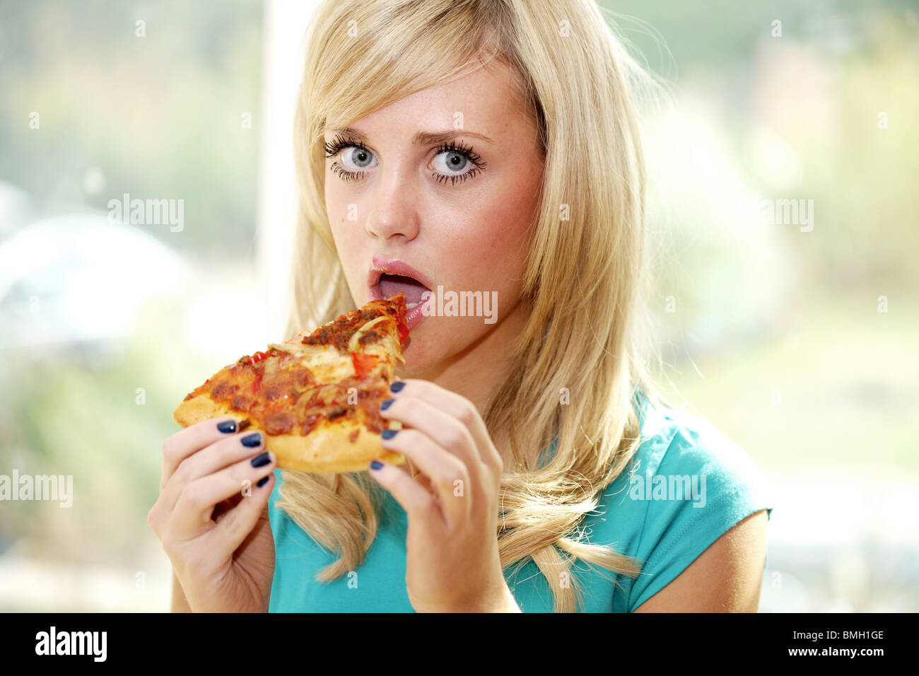Teenage Girl Eating Pizza Slice. Model Released Stock Photo - Alamy