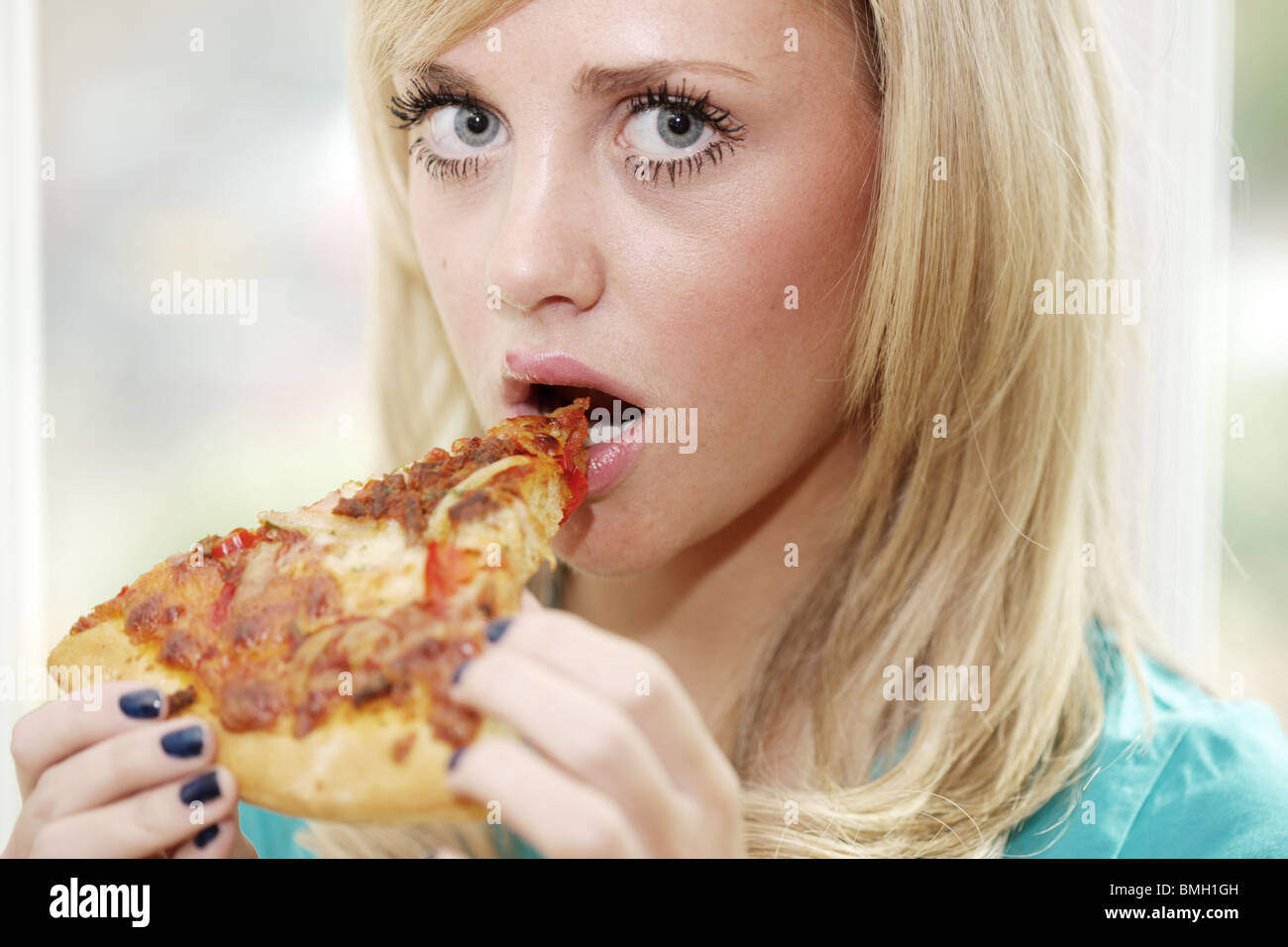Teenage Girl Eating Pizza Slice. Model Released Stock Photo - Alamy