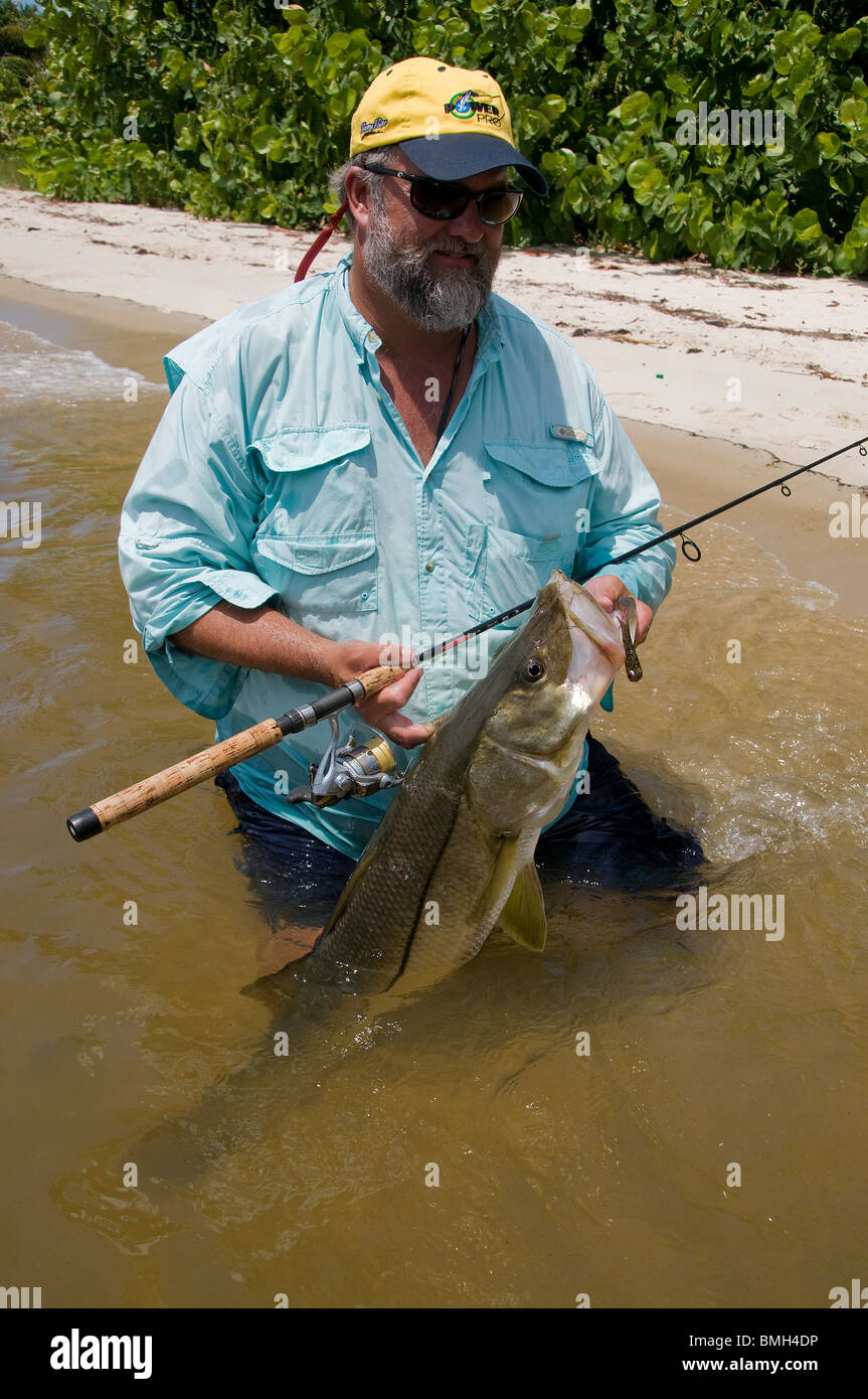 An inshore angler hefts a giant snook caught in Florida's Intracoastal ...