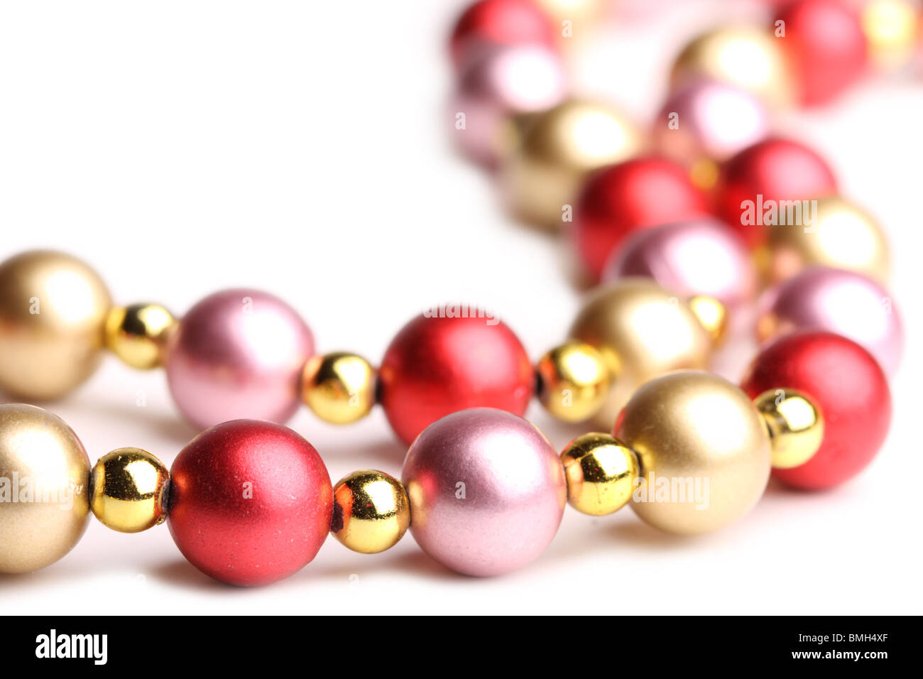 String of beads isolated on white background. Shallow depth of field ...