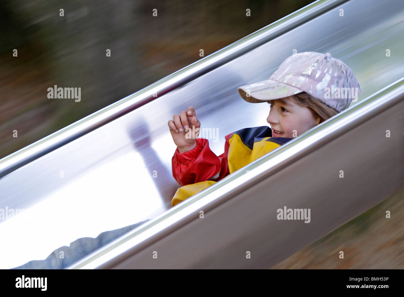 Child going down playground slide hi-res stock photography and images ...