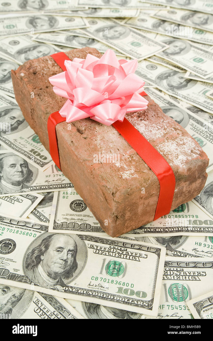 Red Brick Gift and dollars, Concept of joke, make fun of somebody, gift ...