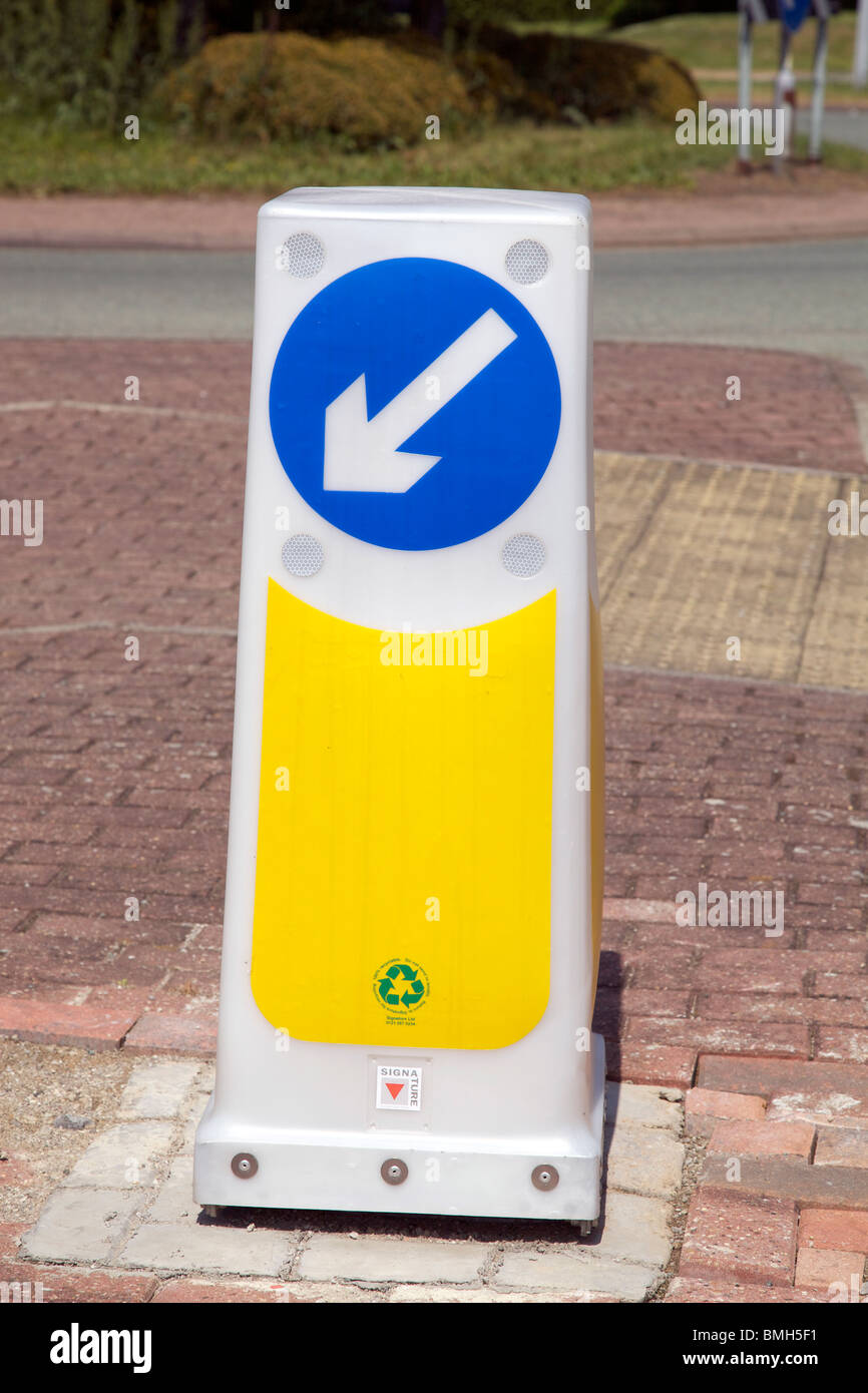 Keep left roadsign on a traffic island Stock Photo - Alamy