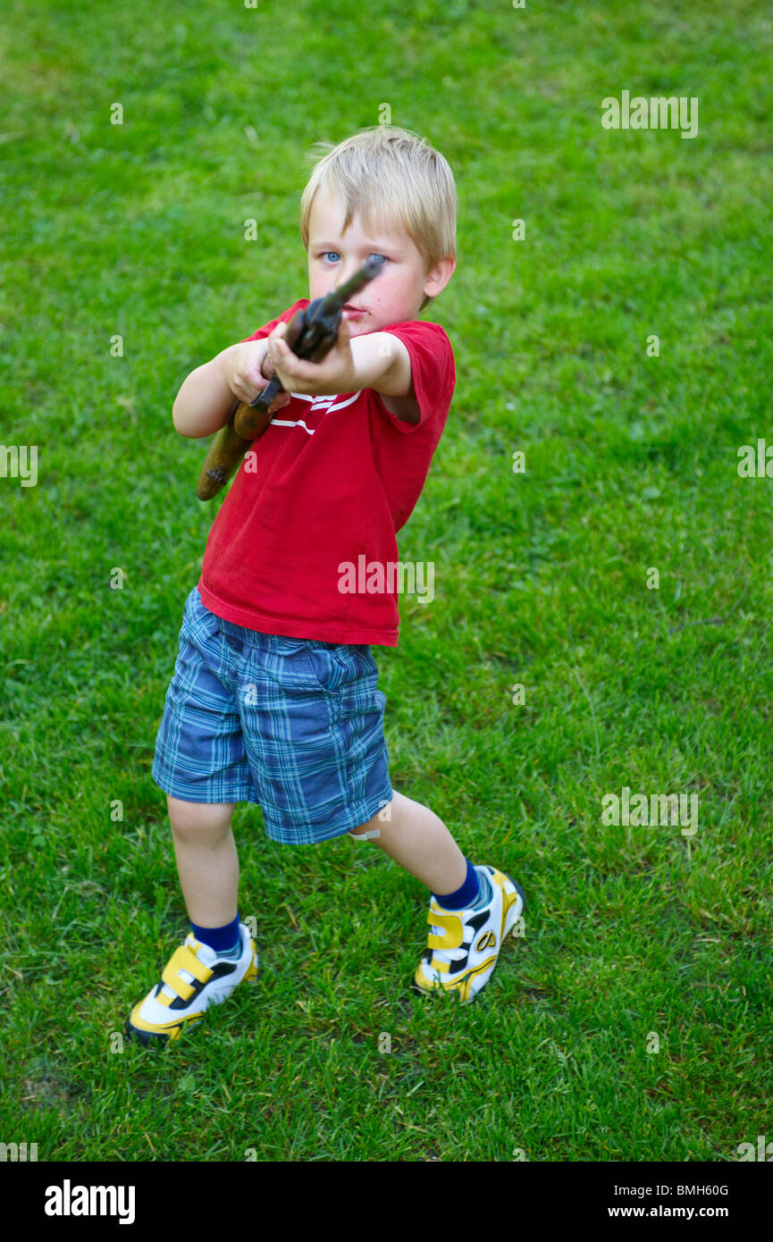 Child blond boy playing with air gun Stock Photo - Alamy