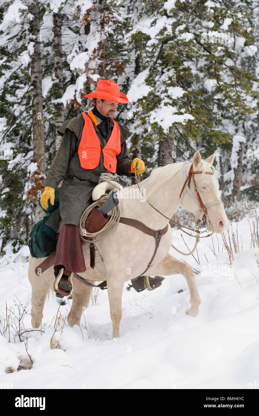 Cowboy riding in autumn snow hi-res stock photography and images - Alamy