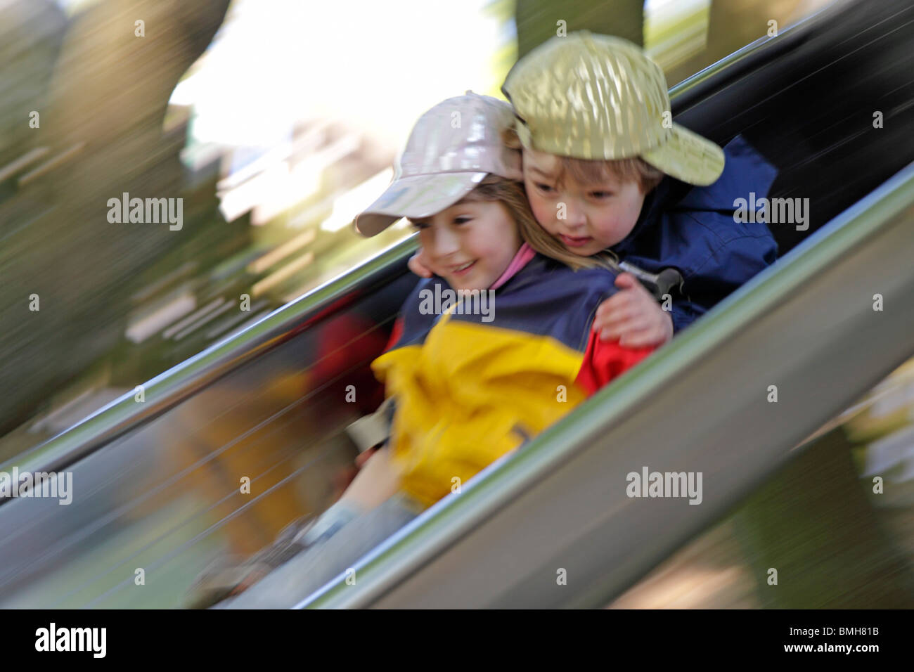 Child going down playground slide hi-res stock photography and images ...