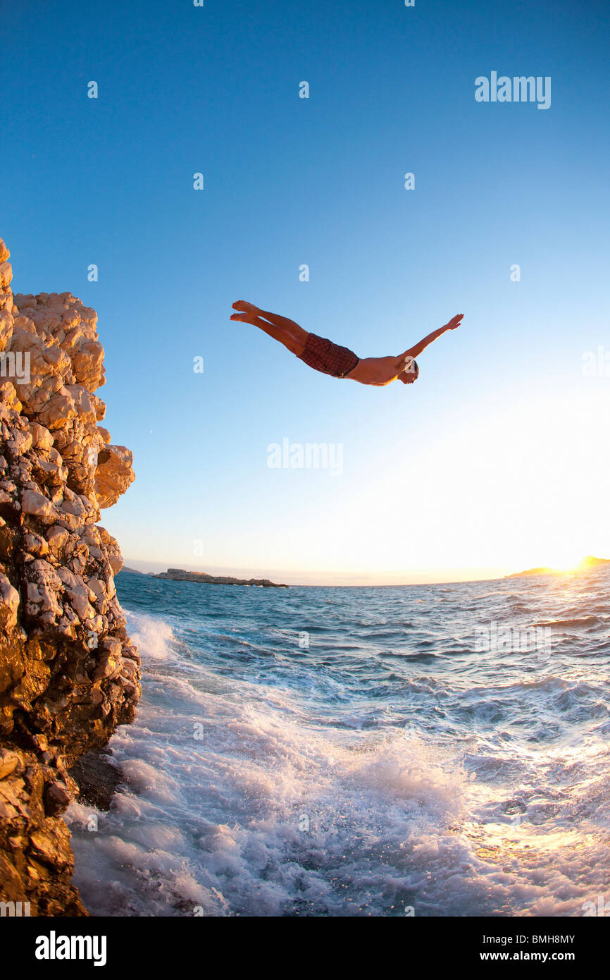 Man cliff jumping Stock Photo - Alamy