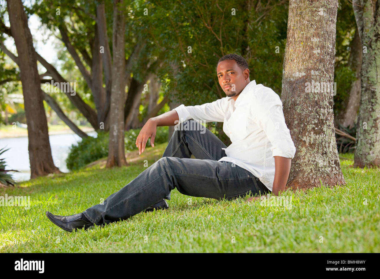 African man leaning against tree hi-res stock photography and images ...