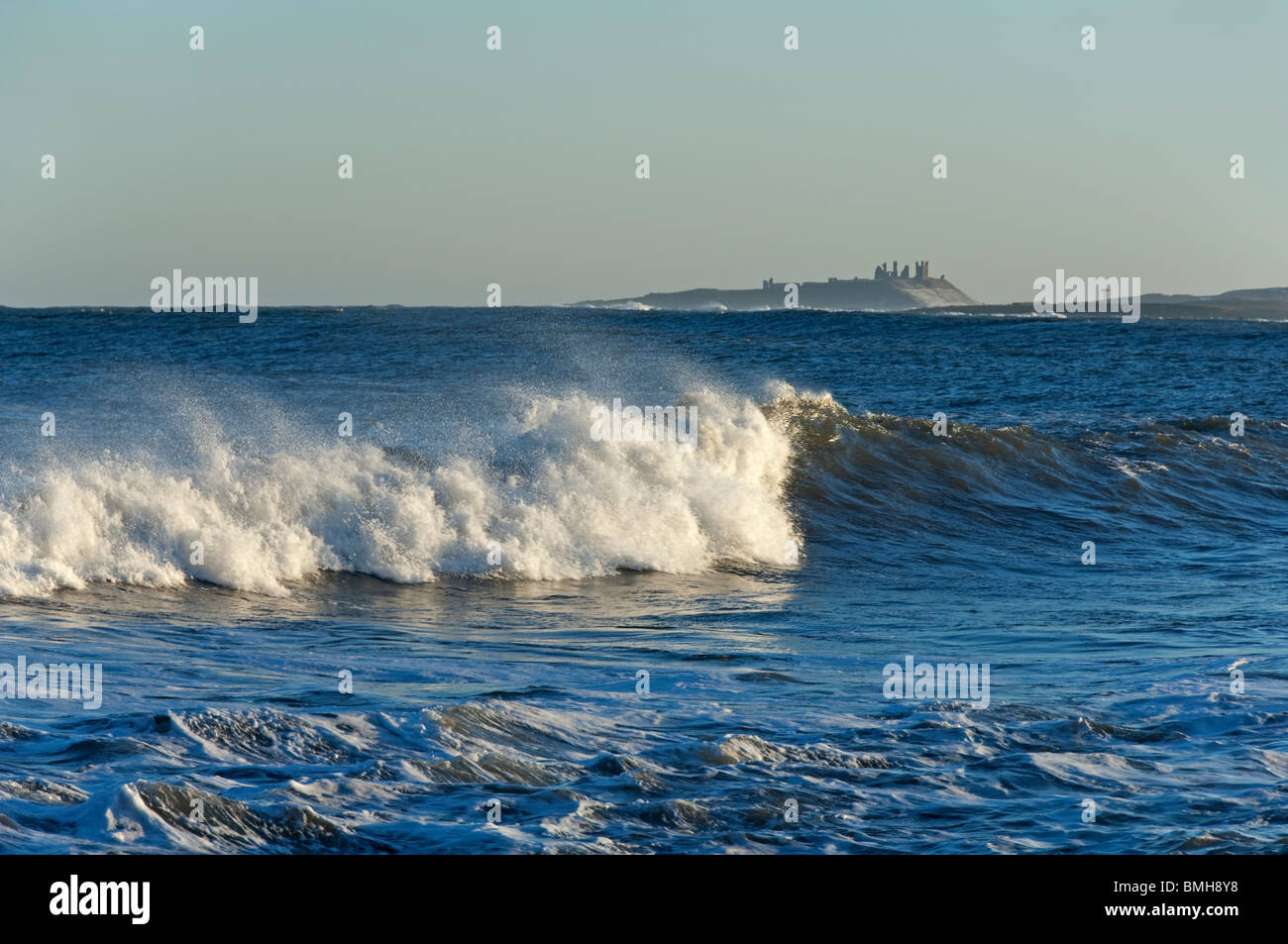 Dunstanburgh Castle from Beadnell harbour, Northumberland, England UK ...