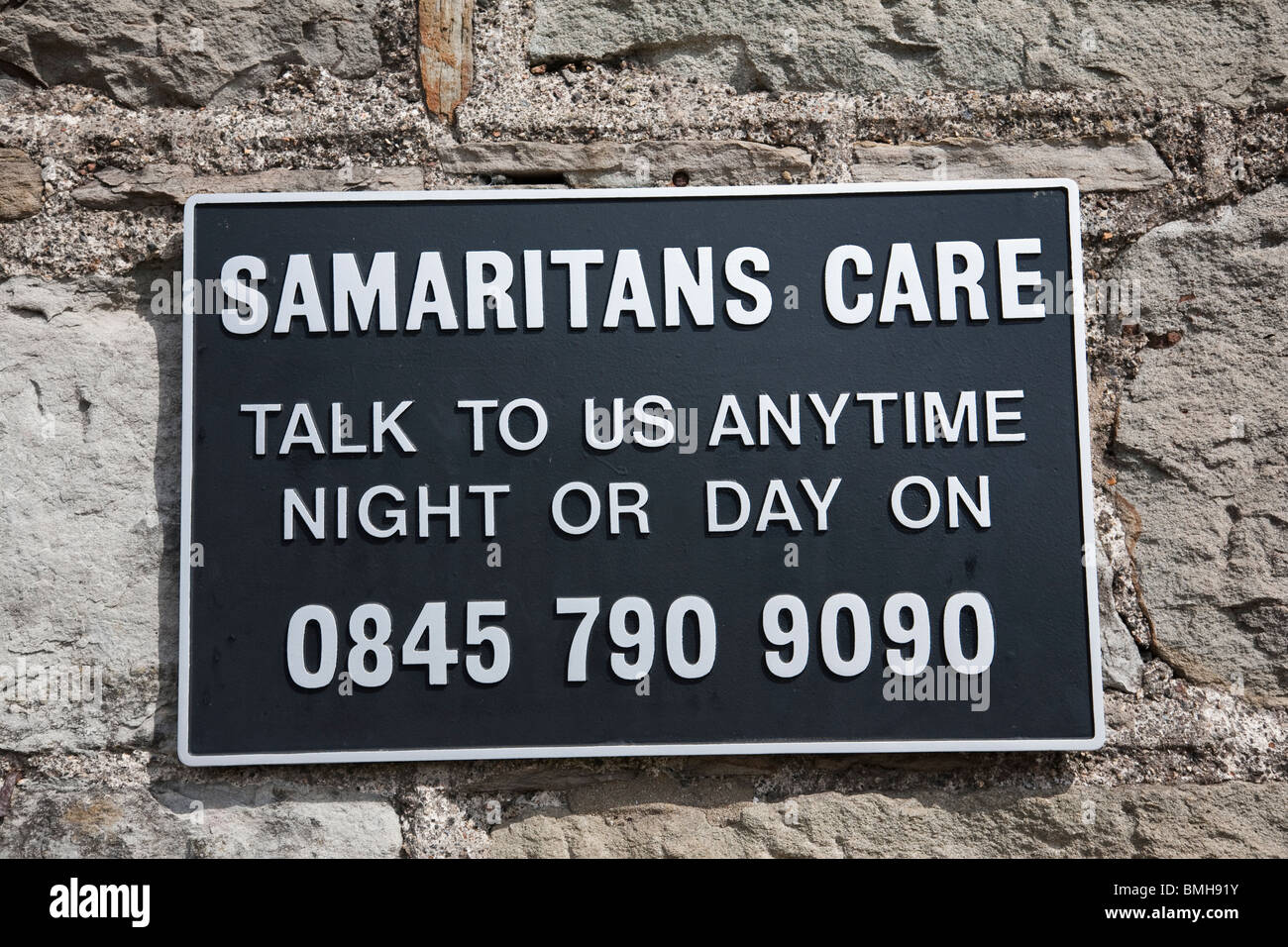 A plaque advertising the Samaritans phone number on the tower of the ...