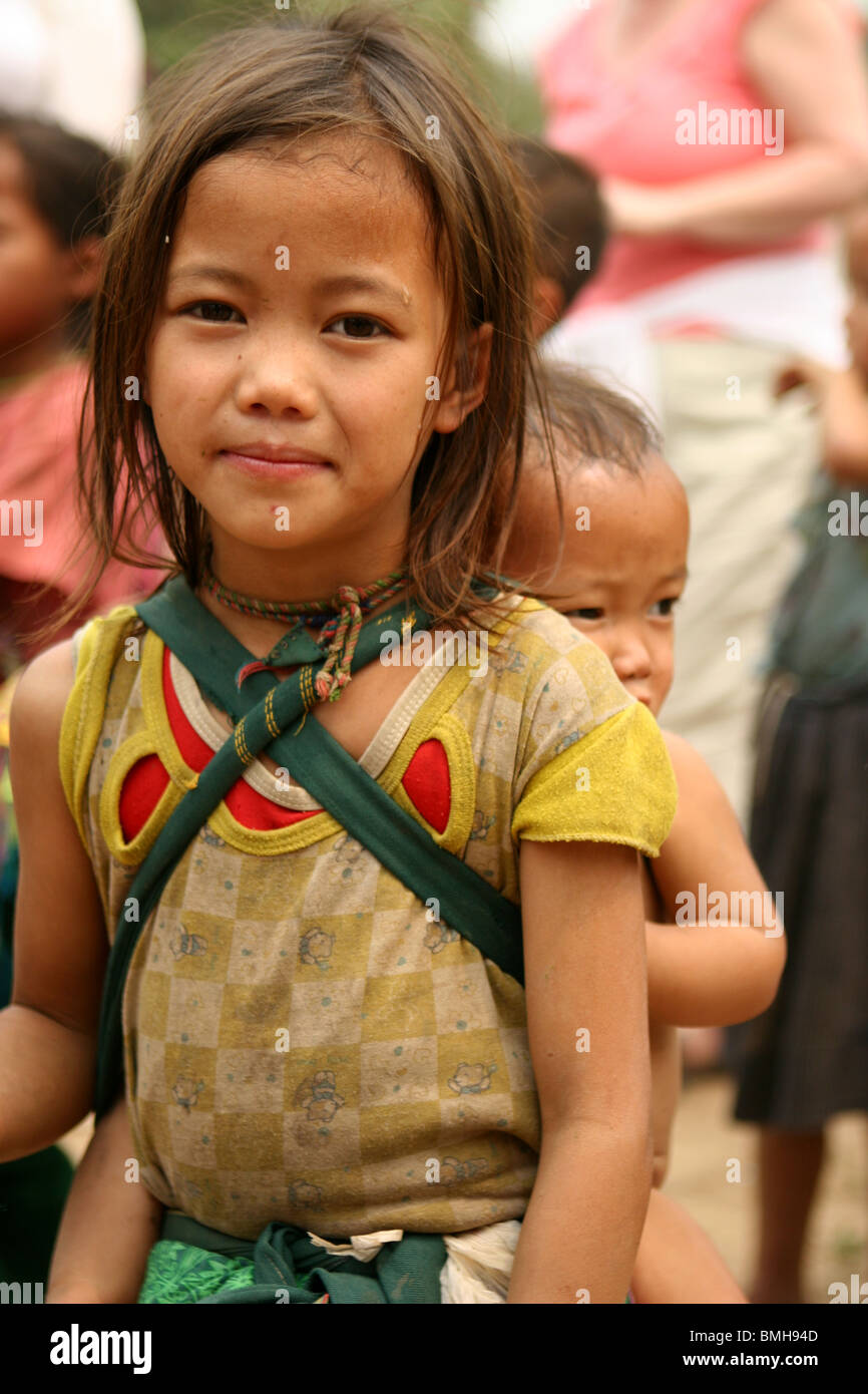 Hmong Child carrying her brother in a small village between Pakbeng and ...