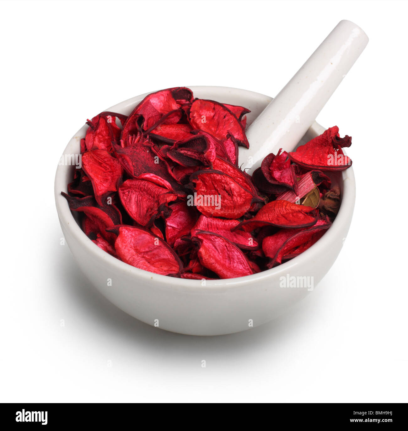 Mortar and pestle with dry rose petals isolated on white background ...