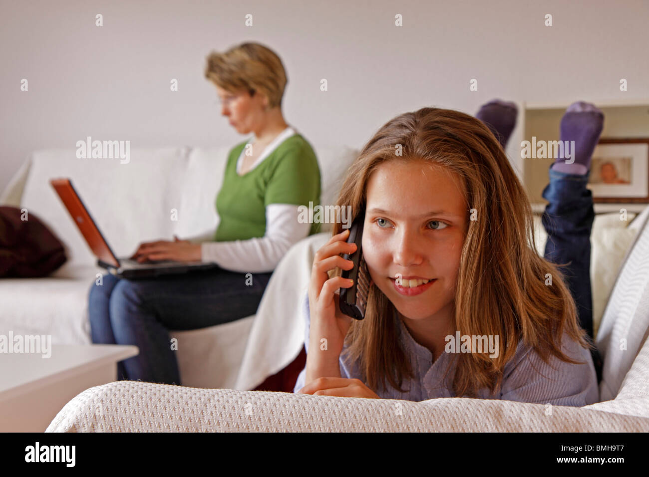 A Mother Trying To Work On Her Computer While Her Daughter Is Talking