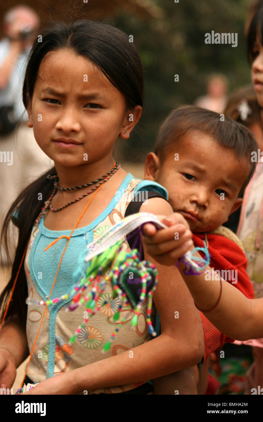 Hmong Child carrying her brother in a small village between Pakbeng and ...