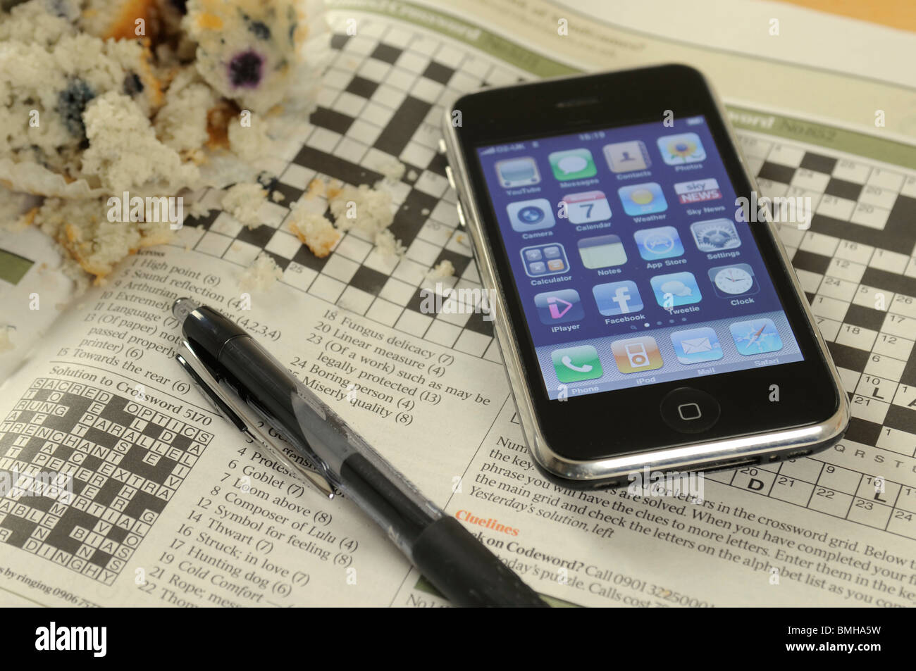 an iphone laying on a crossword puzzle Stock Photo - Alamy