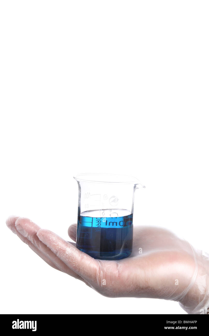 Hand holding medical beaker Stock Photo - Alamy