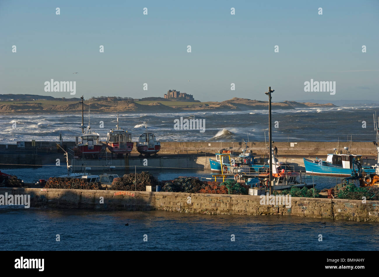 Seahouses harbour looking to Bamburgh Castle, Northumberland, England ...