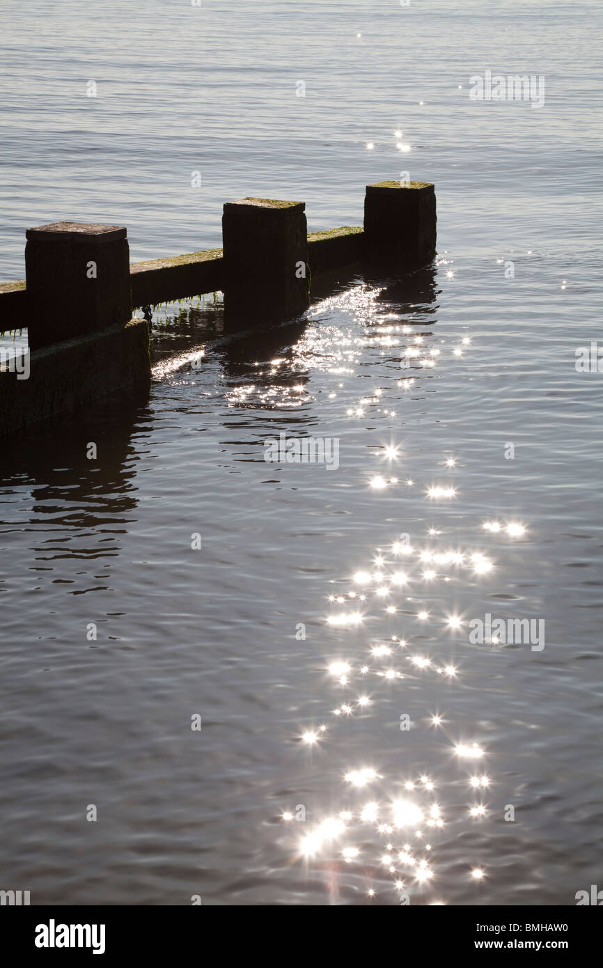 Wooden groynes, breakwater, at Swanage on a calm early morning Stock ...