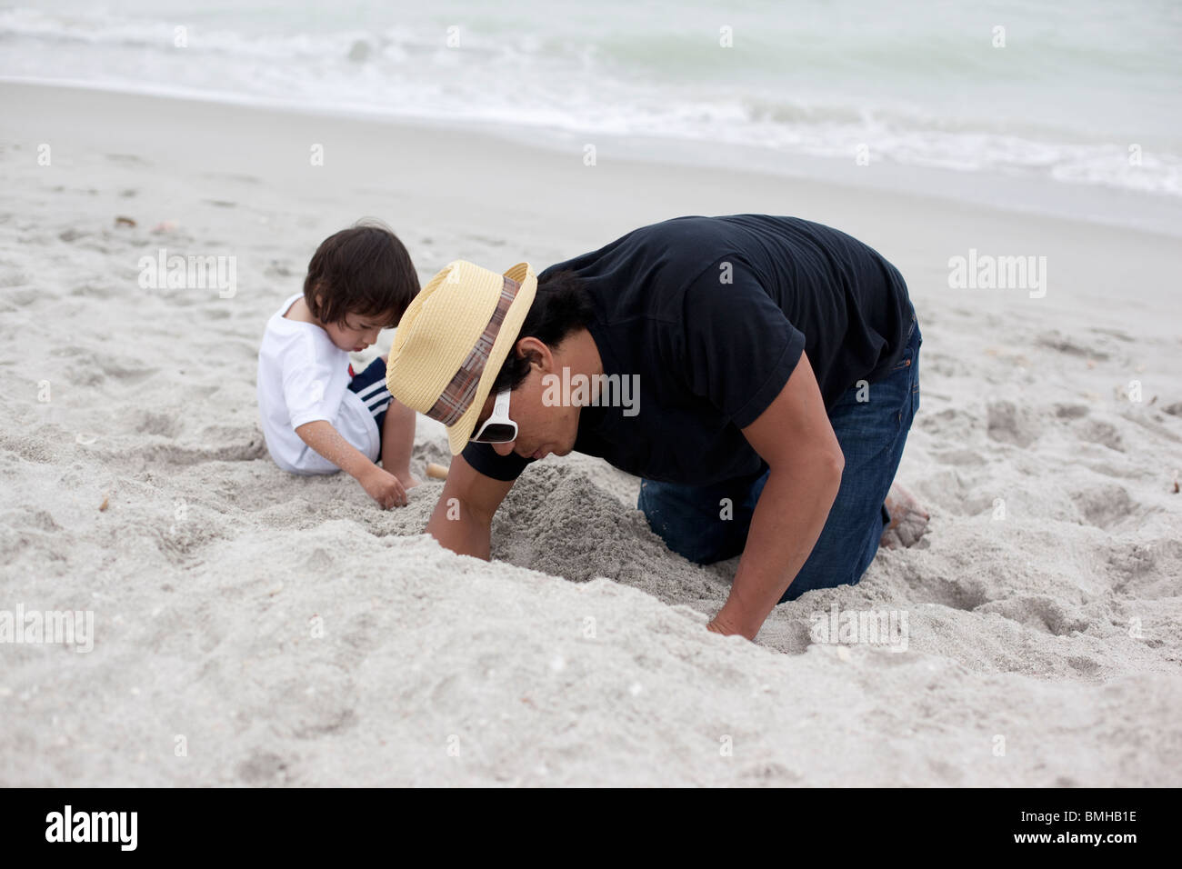 father and sun playing in sand Stock Photo - Alamy
