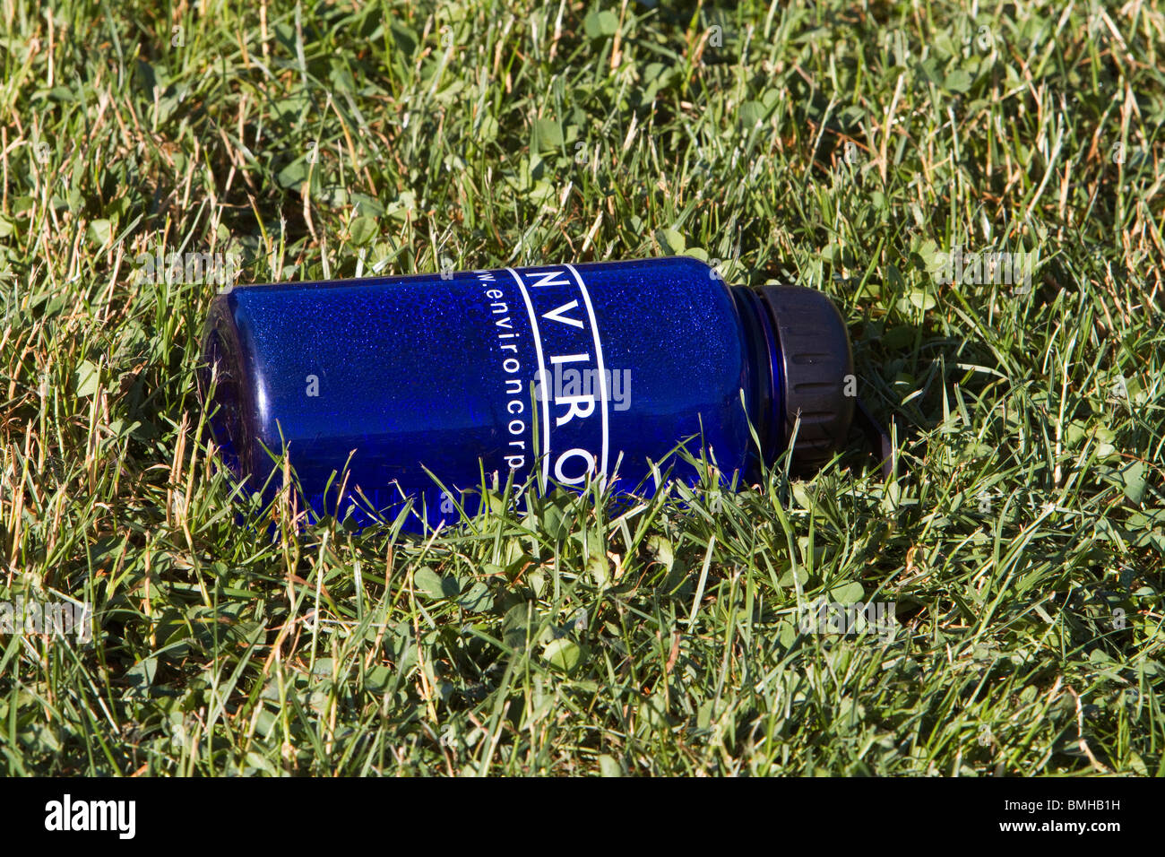 A empty blue plastic water bottle from an environmental company laying ...