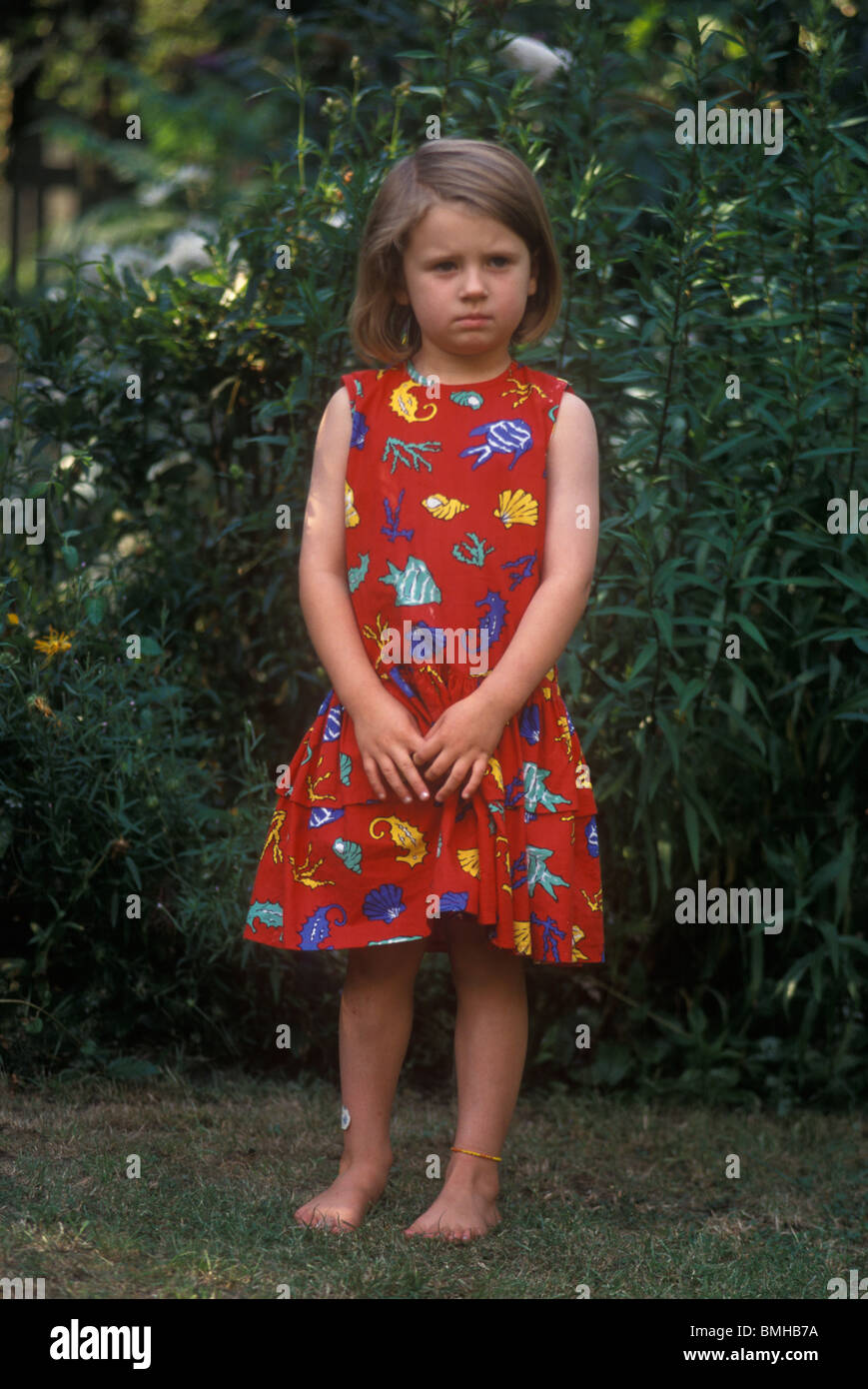 little girl standing looking worried outside Stock Photo - Alamy