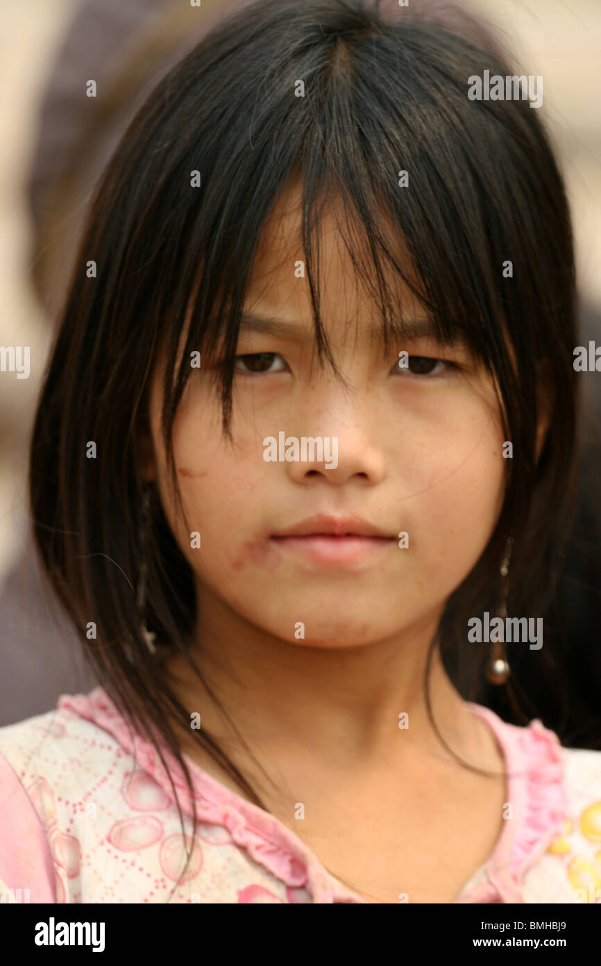 Hmong Child sitting outside a house in a small village between Pakbeng ...