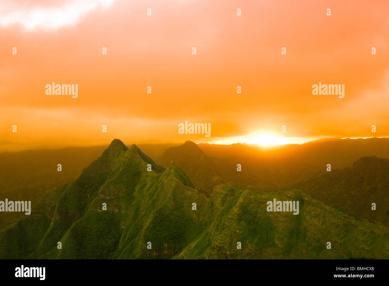 Bright orange sunset over the Koolau mountain range in Oahu, Hawaii ...