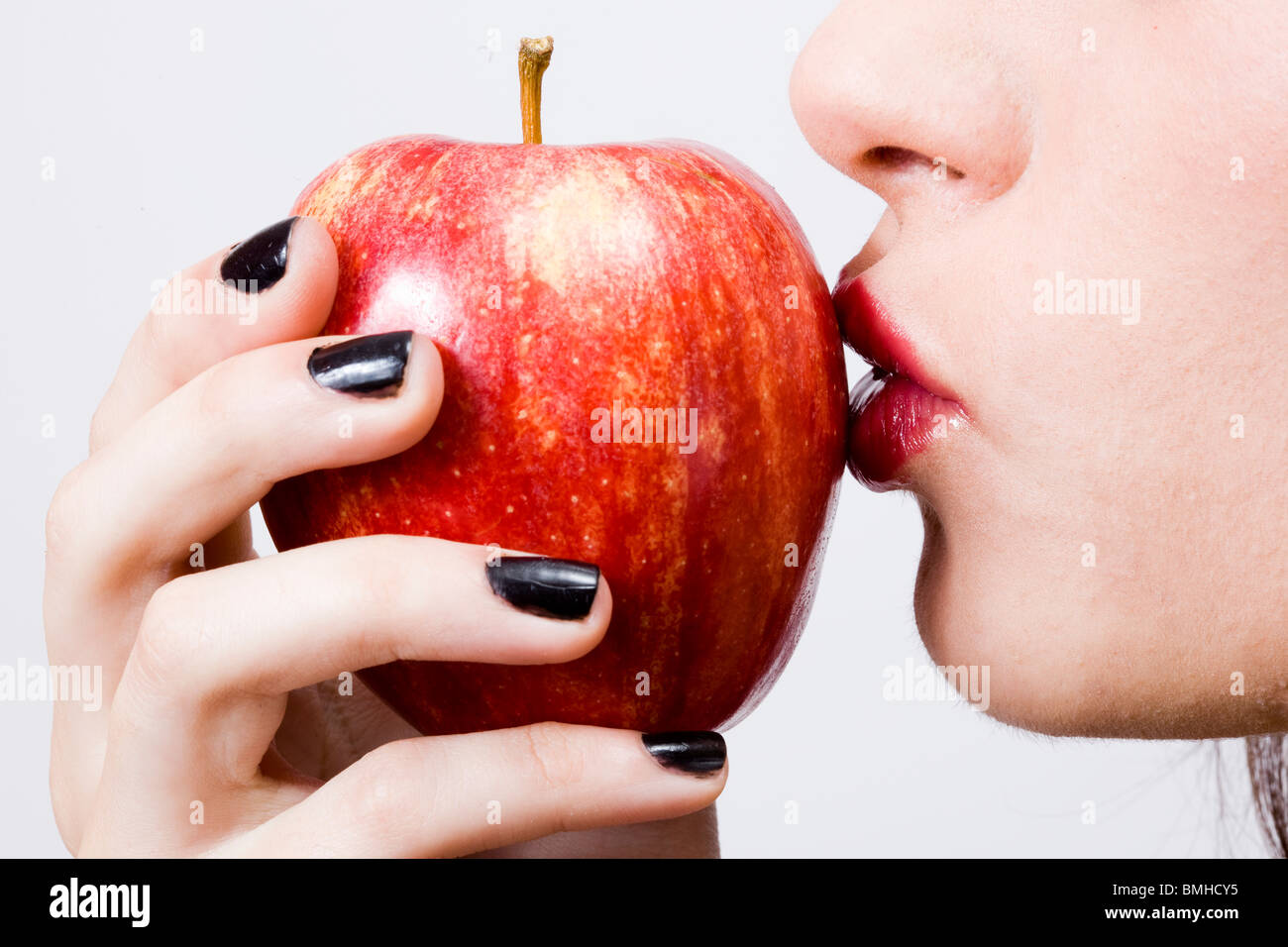 a young pretty girl eating a fresh healthy red apple Stock Photo - Alamy