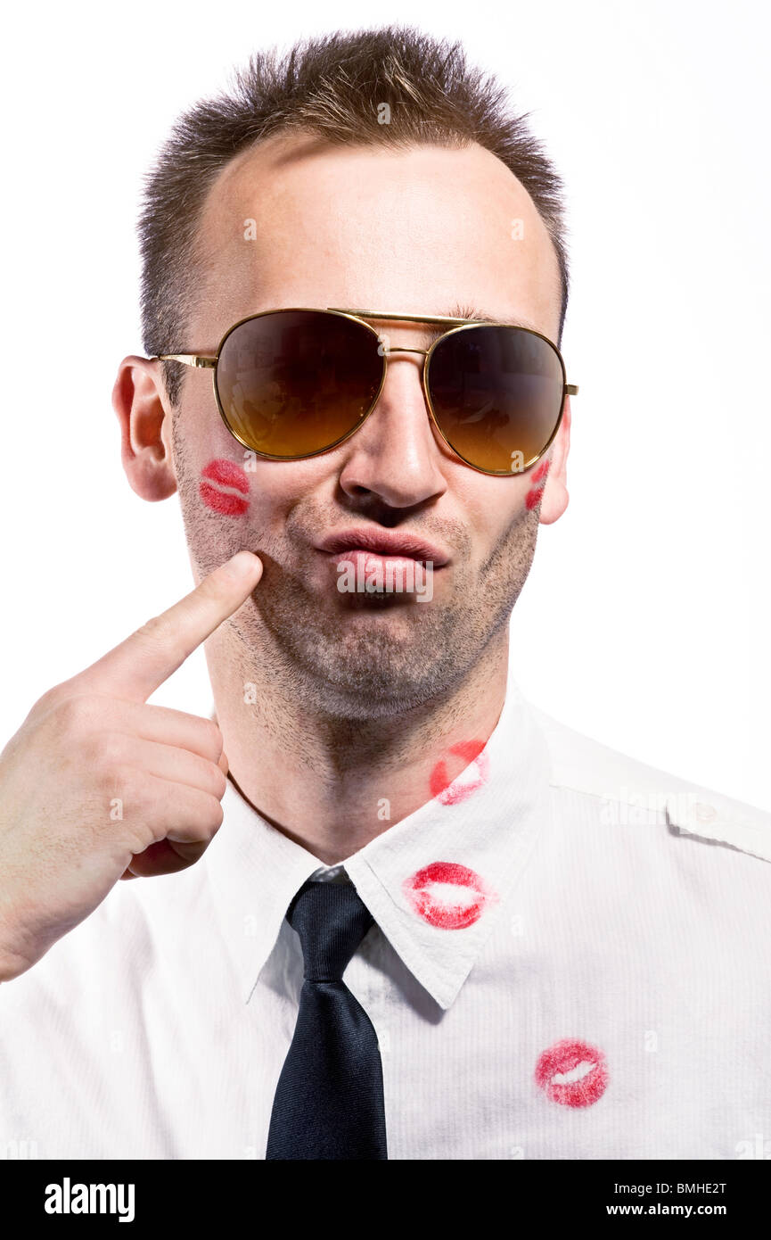 young man pointing on cheek with lips imprint Stock Photo - Alamy