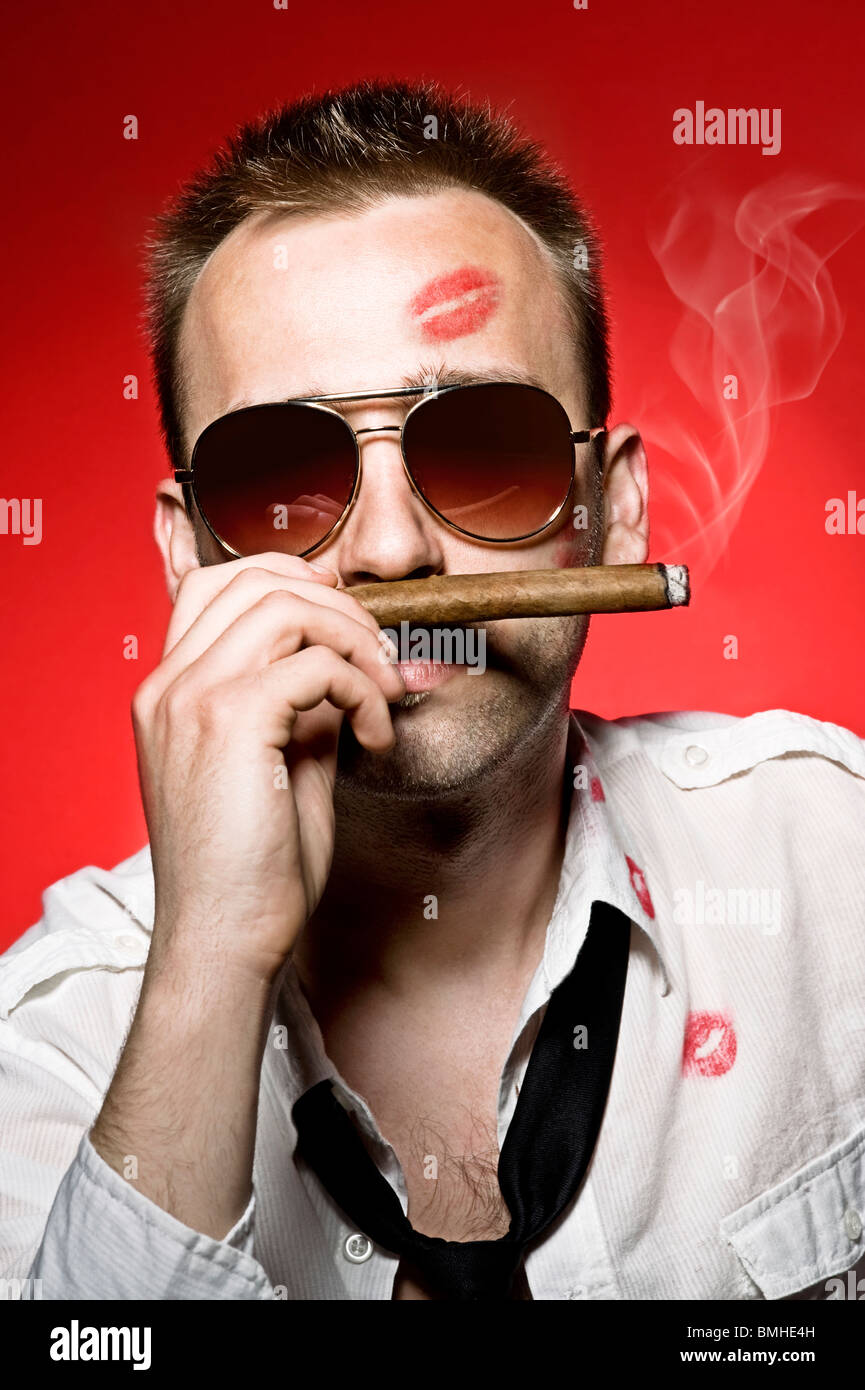 young handsome man with cigar and lips imprints Stock Photo - Alamy
