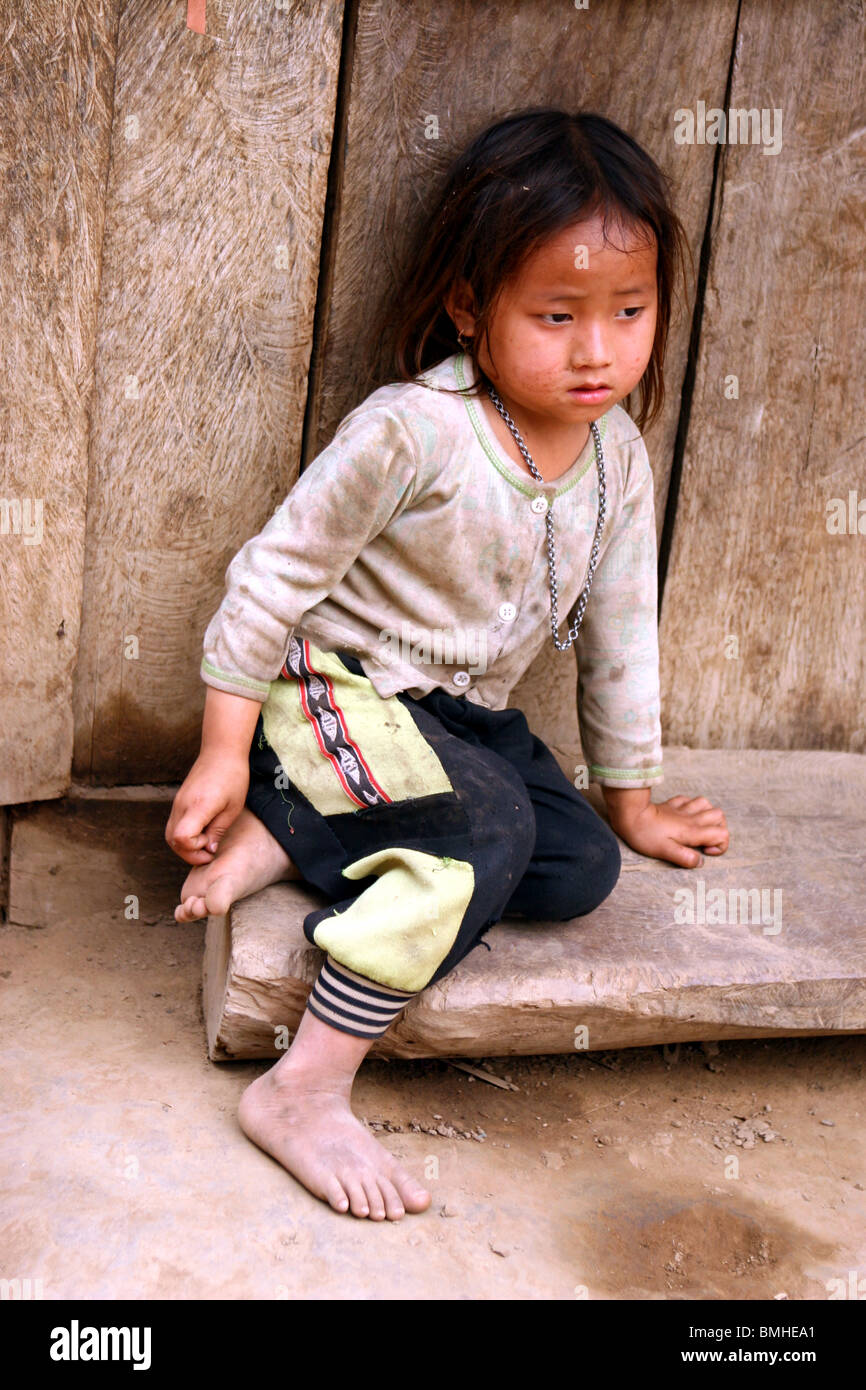 Hmong Child sitting outside a house in a small village between Pakbeng ...