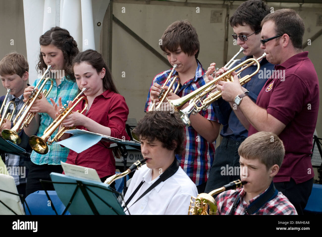 A mixture of school children and teachers performing at a fair Stock ...