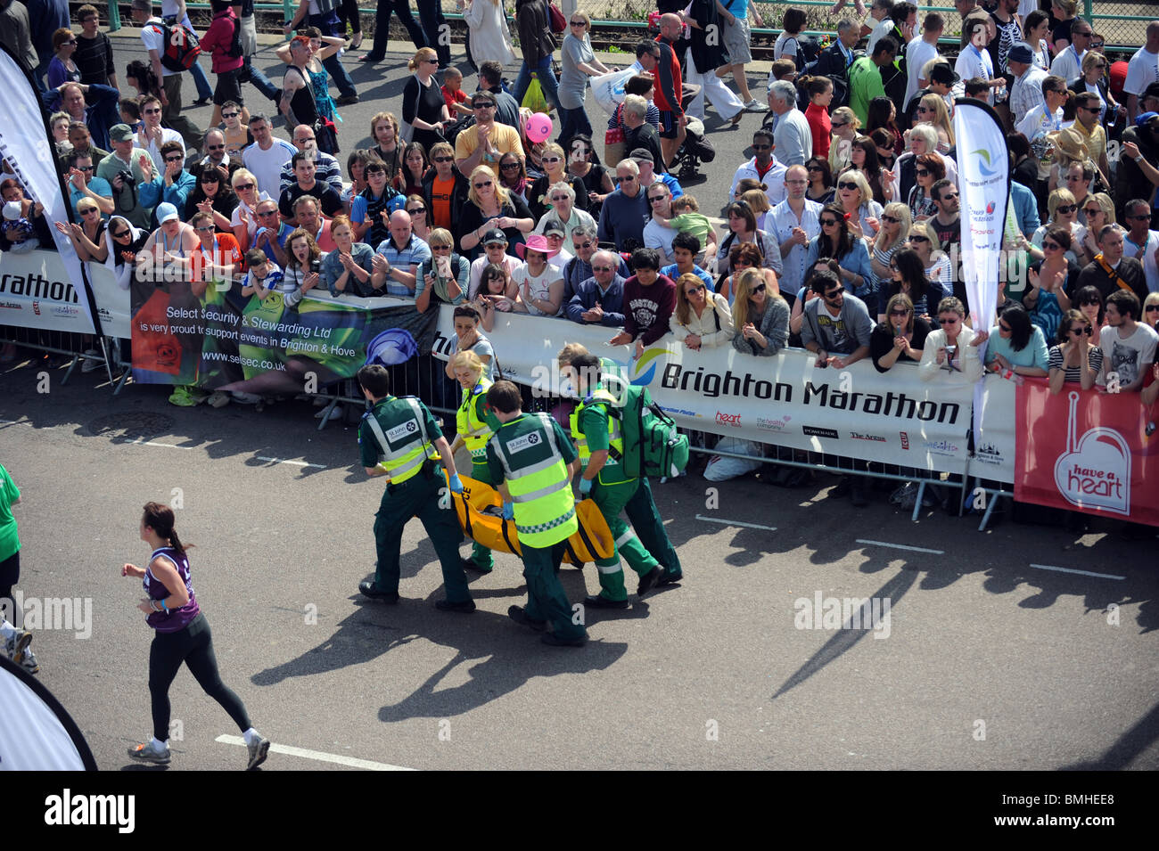 Paramedic's help a runner over the finish line after he collapsed yards ...