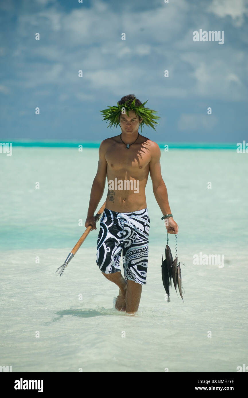 A tahitian fisherman has caught many fishes with a trident harpoon ...