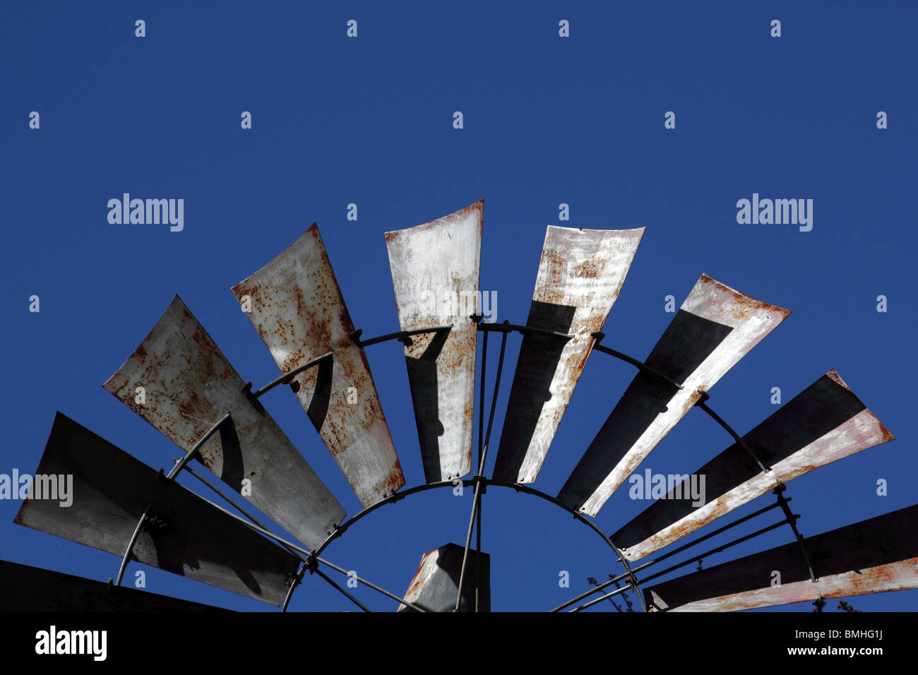 SILVER WINDMILL AGAINST BLUE SKY BACKGROUND BDB Stock Photo - Alamy