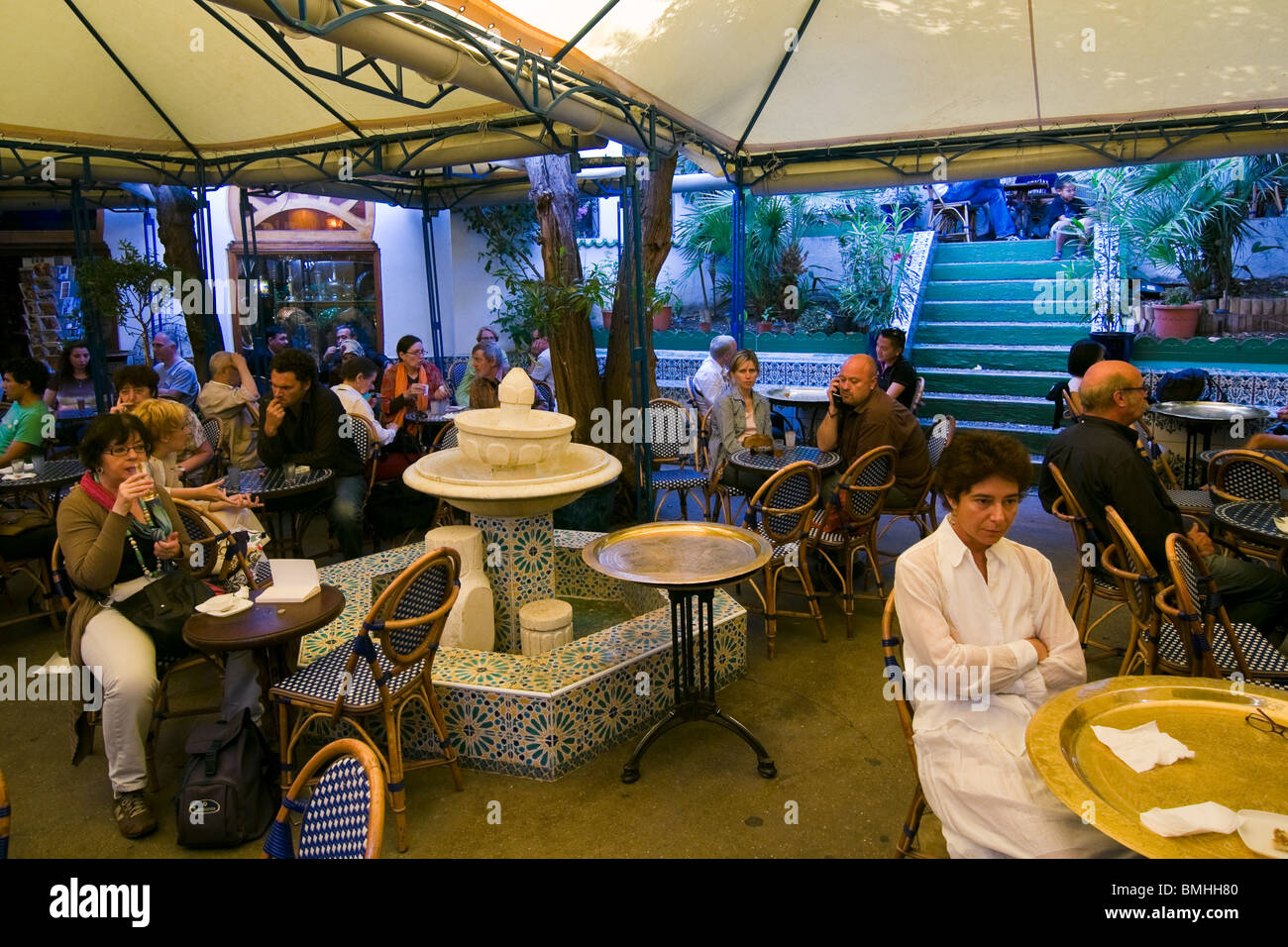 Visitors enjoying a drink at the inner terrace of the Great Mosque café ...