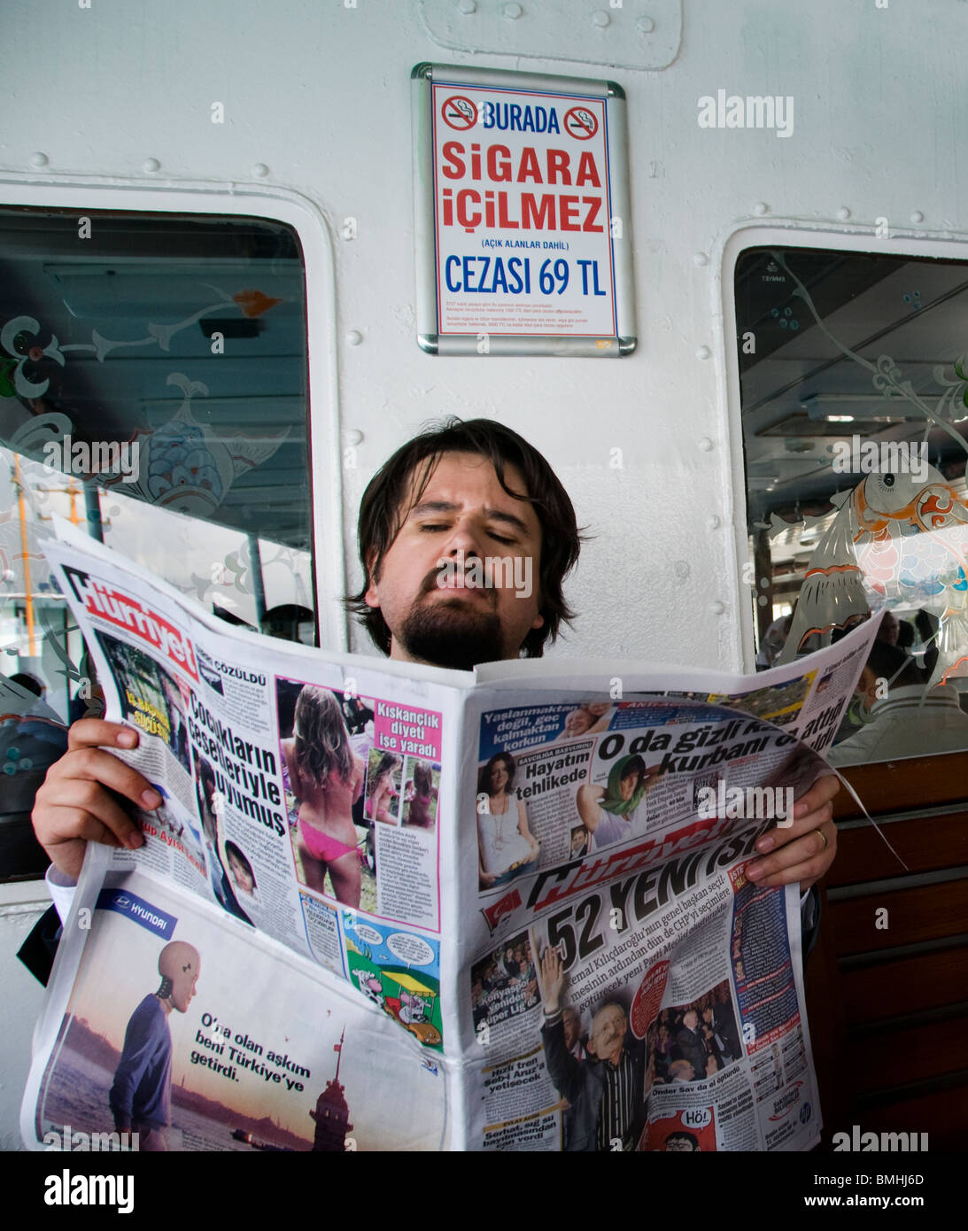 Istanbul Man reading newspaper on the Ferry Turkey Stock Photo - Alamy