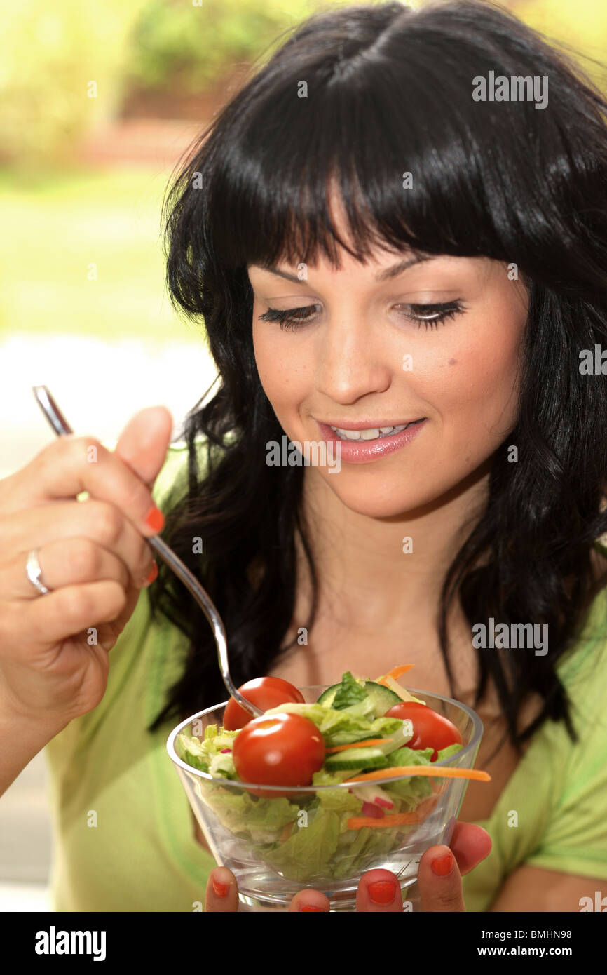 Young Woman Eating Salad. Model Released Stock Photo - Alamy