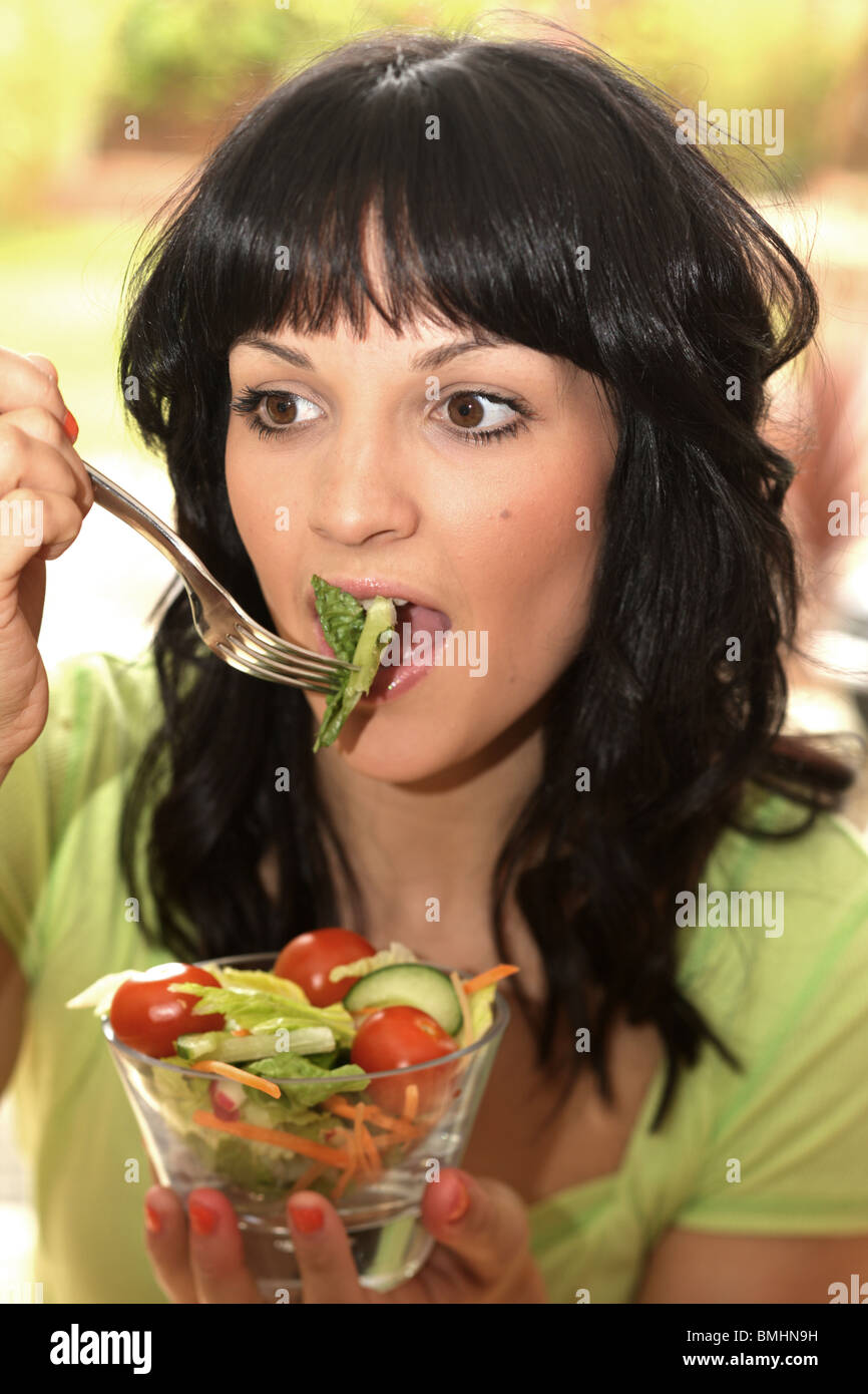 Young Woman Eating Salad. Model Released Stock Photo - Alamy