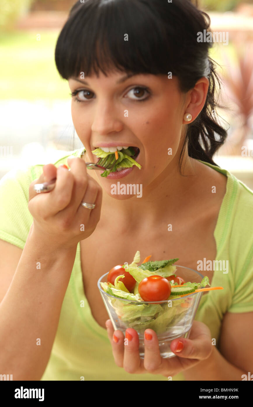 Young Woman Eating Salad. Model Released Stock Photo - Alamy