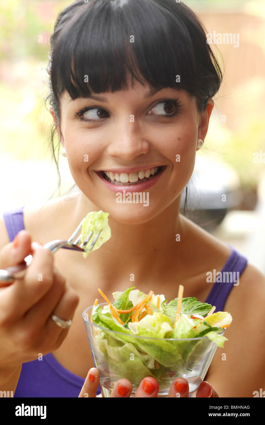 Young Woman Eating Salad. Model Released Stock Photo - Alamy