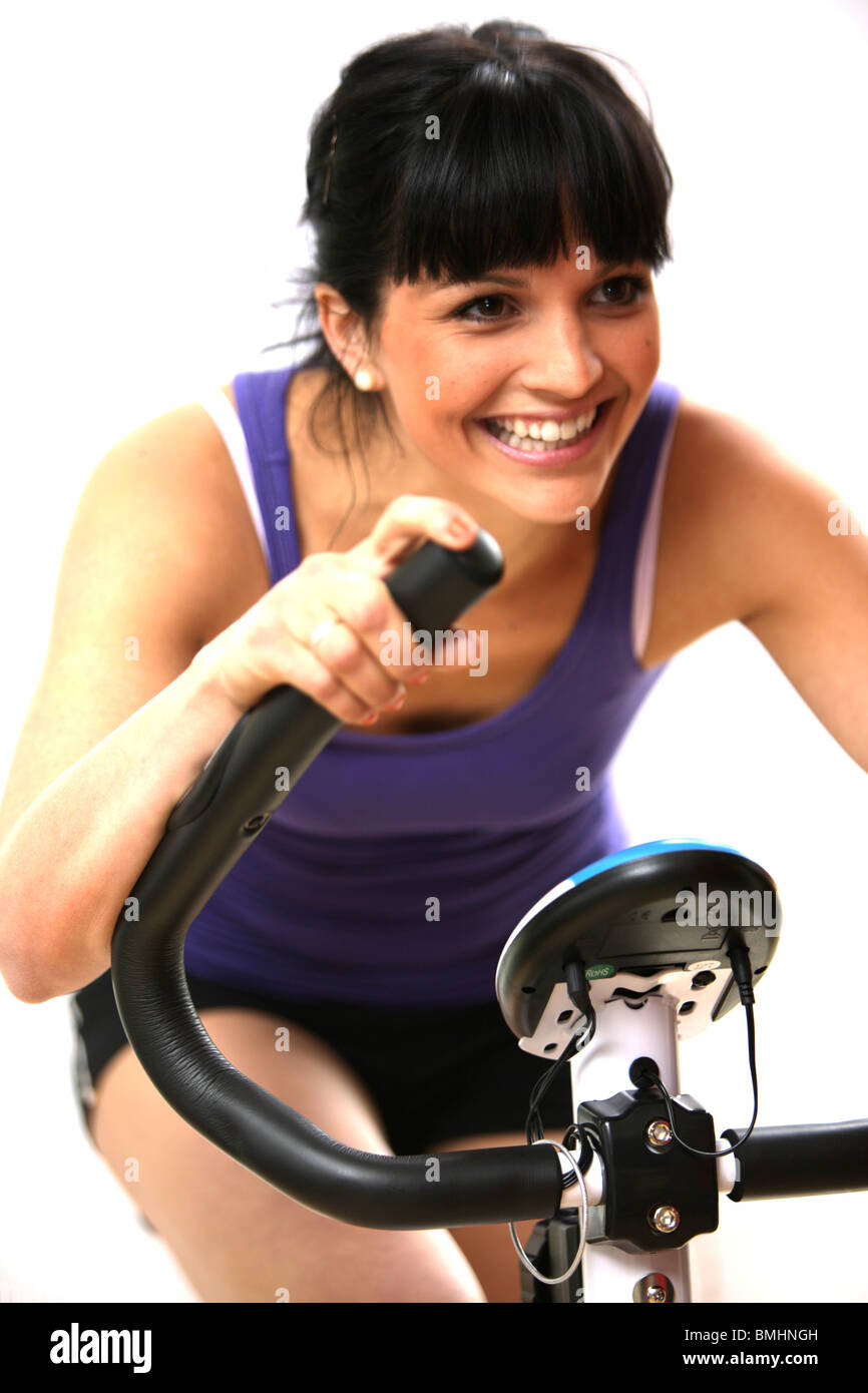 Young Woman Riding Exercise Bike. Model Released Stock Photo - Alamy